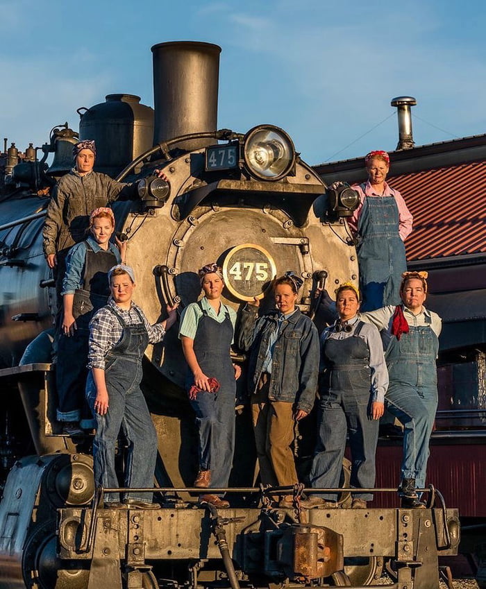 A group of female railroad workers pose in front of a train - 9GAG