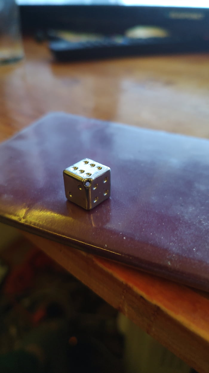 This old monopoly dice has holes in 2 corners to counter choking ...