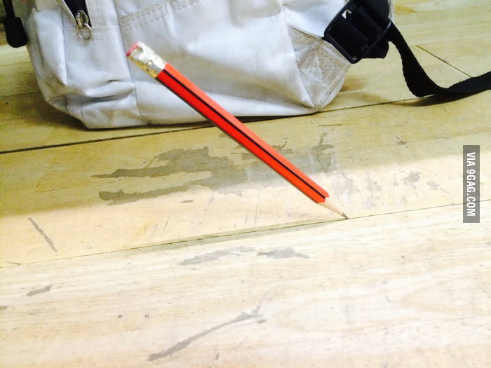 My friend's pencil fell off the table and landed in between two planks ...