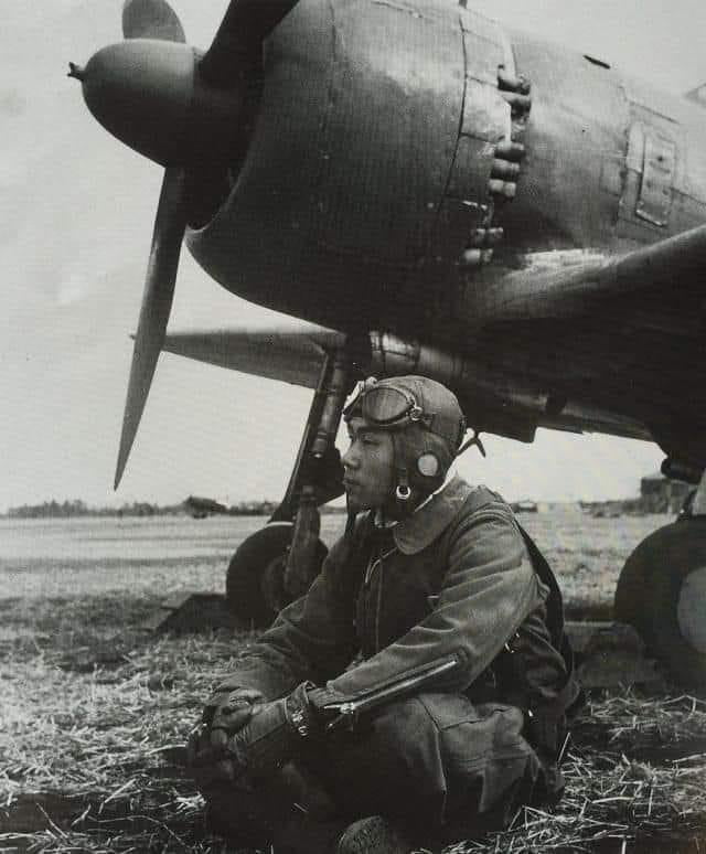 Japanese army pilot sitting by his Nakajima Ki-43-II “Hayabusa” fighter ...