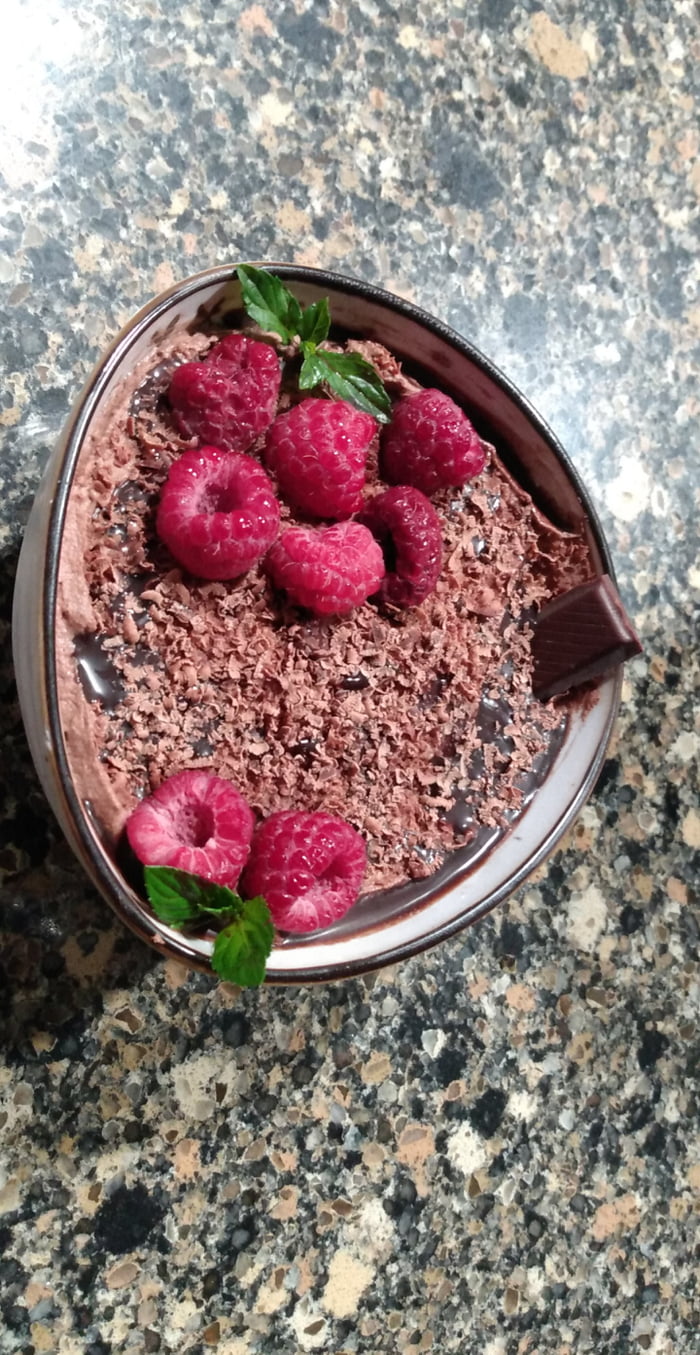 Dark chocolate mousse with shaved dark chocolate, chocolate syrup, and ...